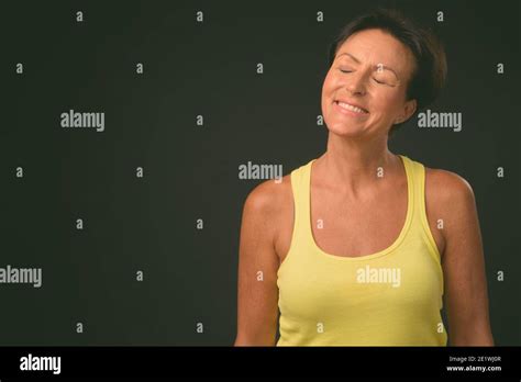 Mature Beautiful Woman With Short Hair Against Black Background Stock