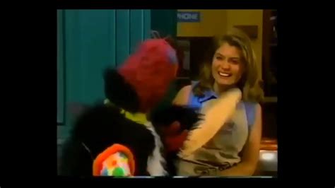 Sesame Street Telly Pretends To Be A Penguin By Holding A Party Hat