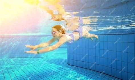 Premium Photo Beautiful Girl Swimming Under Water In Blue Pool