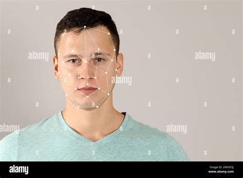 Facial Recognition System Young Man With Biometric Identification Scanning Grid On Beige