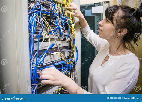 Woman Switches The Wires In The Patch Panel The Specialist Works In The Server Room Of The Data