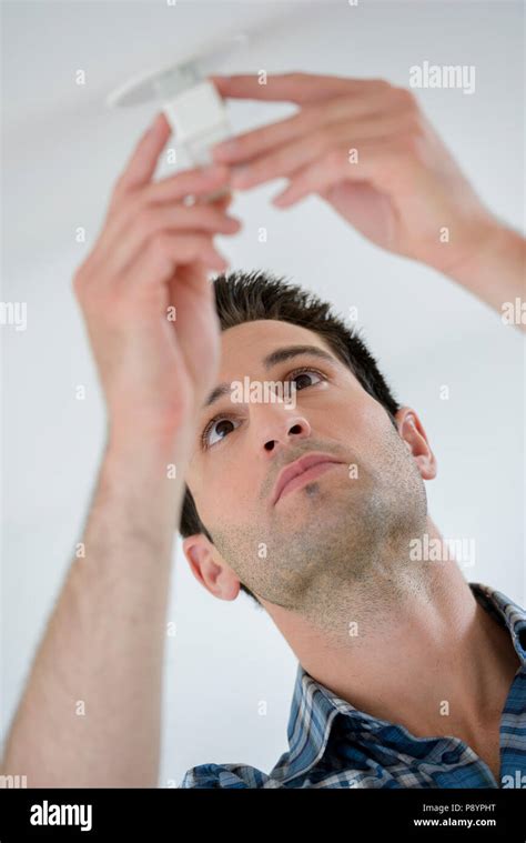 Man Attaching Light On The Ceiling Stock Photo Alamy
