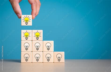 Businessman Hand Placing Wooden Blocks With Brainstorming Glowing Light