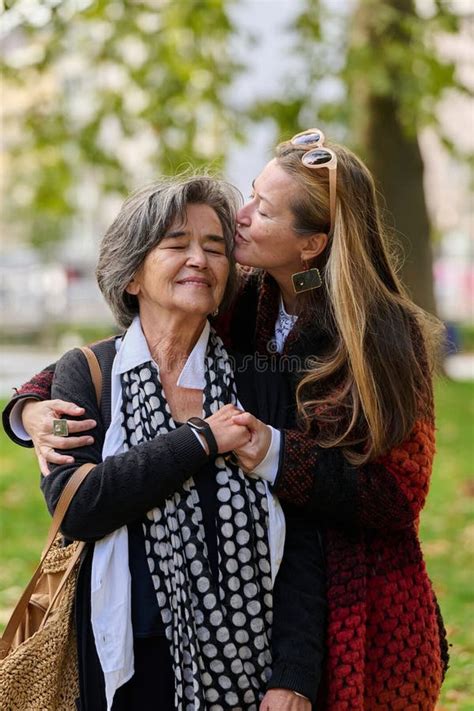 A Heartfelt Embrace A Daughters Support For Her Mother On A Beautiful
