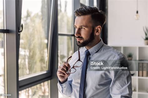 잠겨 수염된 사업가 안경 들고와 창 현대 사무실에서 보고 경영자에 대한 스톡 사진 및 기타 이미지 경영자 기업 비즈니스 기업 재무와 산업 Istock