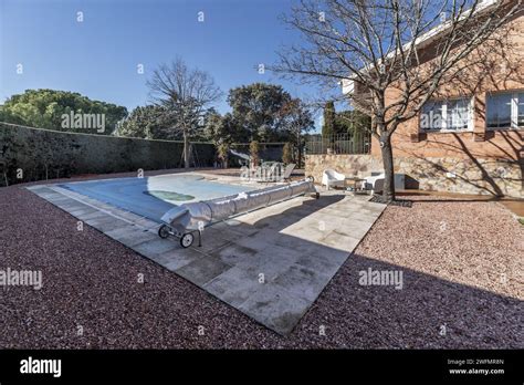 A Swimming Pool Within A Plot With A Large Awning Covering The Pool