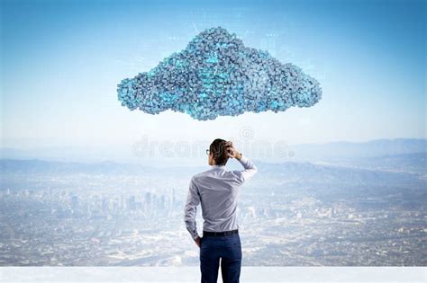 Back View Of Businessman Standing Under Abstract Digital Cloud With