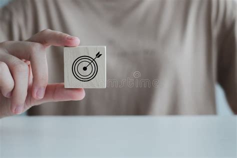 dart board symbols on top of wooden block goal or agenda setting in