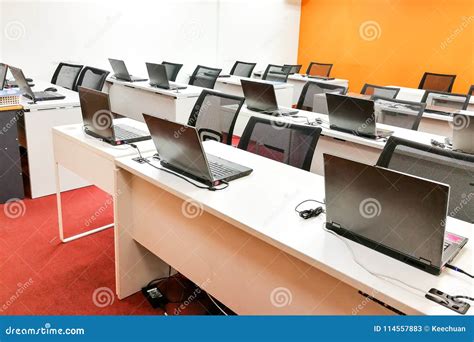 empty computer classroom with monitors on top of table stock image