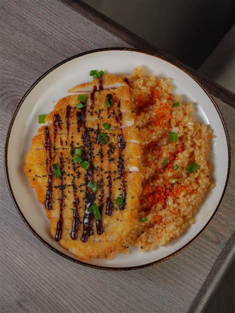 Flavorful 가금류 고명 곡물 단백질 도금 접시 레시피 맛있는 맛있는 식사 메인 코스 목조 테이블 미식가 바삭바삭한 바삭한 치킨 밥 볶음밥