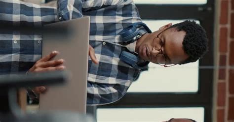 Vertical Video Coders Talking About Algorithms Holding Laptop Pointing