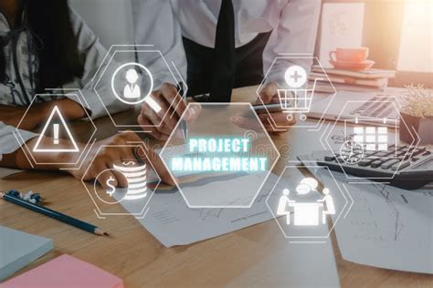 Two Colleagues Discussing Data With Project Management Icon On Virtual Screen Stock Image