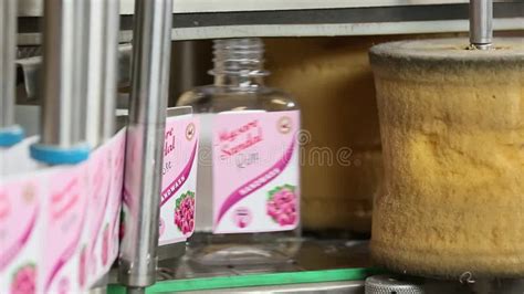 A Closeup Of Plastic Bottles Being Labelled By A Labelling Machine Stock Footage Video Of