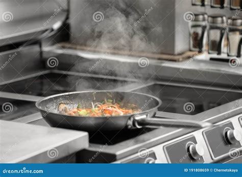 Cooking Food On Stove In Restaurant Kitchen Stock Image Image Of