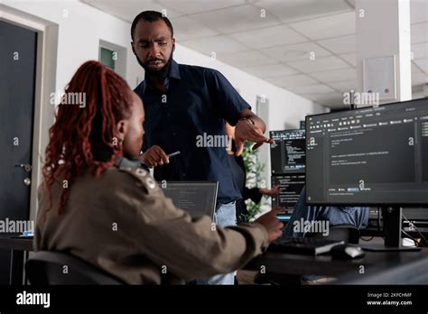 African American Engineers Typing Machine Learning Html Code On Computer Sitting At Desk Table