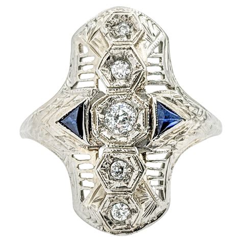 Antique Art Deco Era Diamond And Sapphire Shield Ring In White Gold For