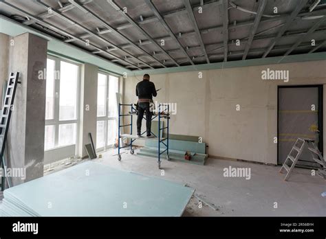 Drywall Installers Men Holding A Gypsum Board Figured Cut Stock Photo Alamy