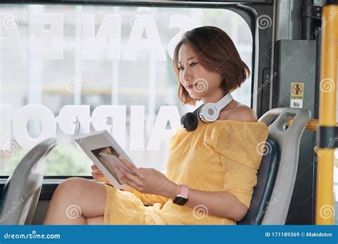 Young Woman Reading Book While Moving In The Modern Tram Happy