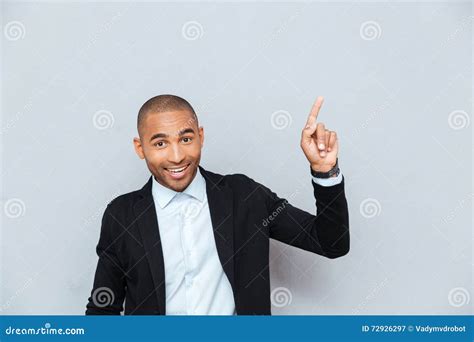 Portrait Of A Happy Young Man Pointing Finger Up Stock Image Image Of