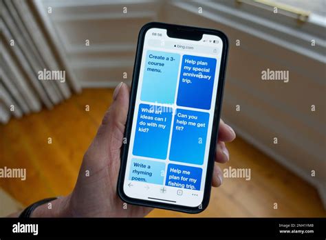 person holds mobile phone showing new microsoft chatgpt openai bing