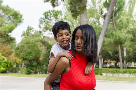 Happy Mother And Son Enjoying Together Outdoors In A Park Stock Image Image Of Carrying