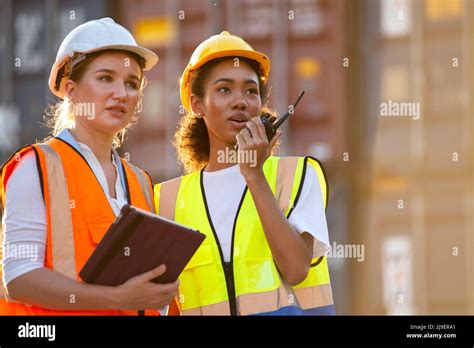Businesswoman And Logistics Woman Worker Checking Containers Box And Loading Products In