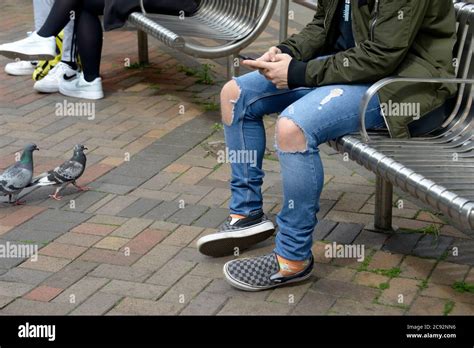 Guy Sat With Ripped Jeans Stock Photo Alamy