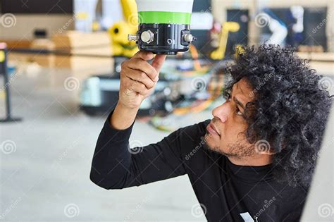 Engineer Inspecting Robotic Gripper Arm In A High Tech Workshop Stock Image Image Of Advanced