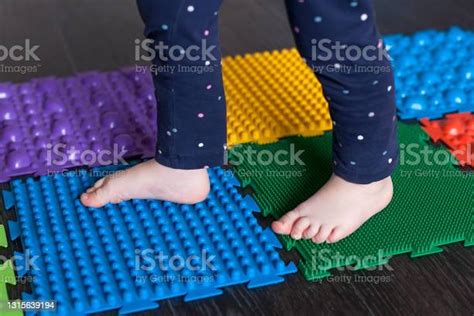 정형 외과 매트에 작은 아이의 다리 걷기와 발의 올바른 아치를 형성하기위한 밝은 표면 마사지 퍼즐 매트 깔개에 대한 스톡 사진 및 기타 이미지 Istock