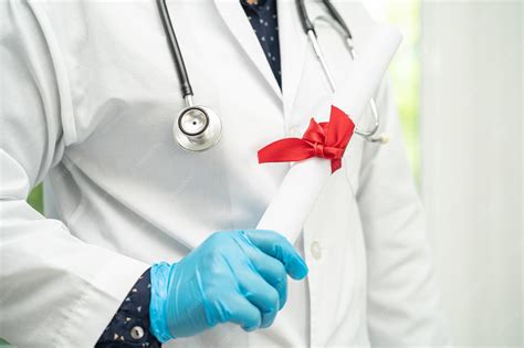 Premium Photo Doctor Holding Diploma Medical Degree In Hospital