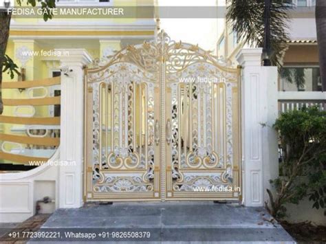 A Large White Gate In Front Of A Yellow House