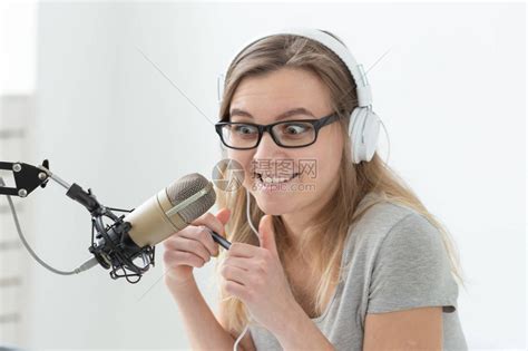 电台主持人概念作为电台主持人的女坐在工作室的白色背景高清图片下载 正版图片506196533 摄图网