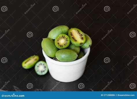 New Zealand Exotic Food Berry Nergi Or Small Kiwi In A White Plate Grey Stone Background