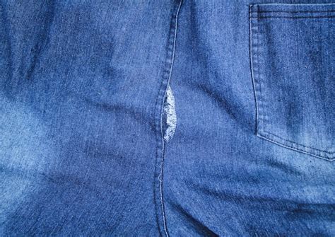 Premium Photo Ripped Jeans At The Back Of The Butt The Concept Of