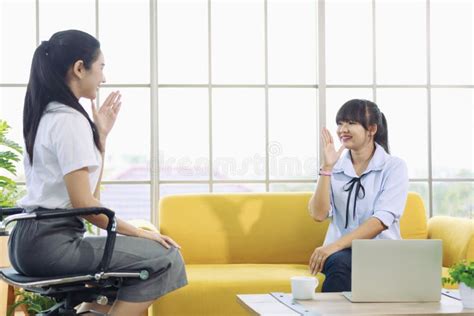 The Sign Language Instructor Teaching A Beautiful Woman To Learn Deaf