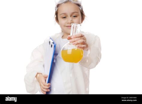 Selective Focus On A Glass Laboratory Flask With Yellow Liquid Chemical In The Hands Of A Smart