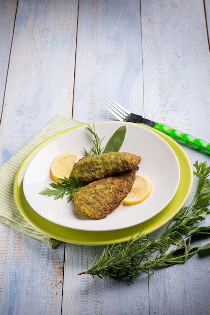 Premium Photo Breaded Fish With Aromatic Herbs