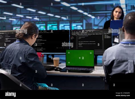 multiracial people in data center updating systems with green screen