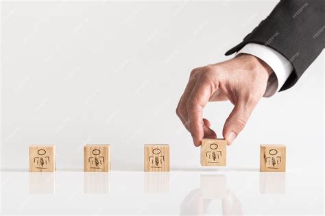 Premium Photo Businessman Hand Arranging Wooden Blocks With Small People Images Team Building