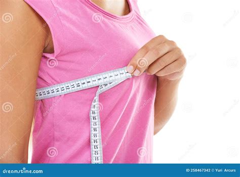Finding The Right Bra Size Is Important A Woman Measuring Her Bust With A Measuring Tape