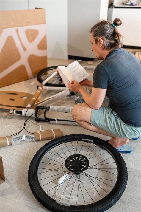 A Man Is Inside Working On Assembling Bike Handlebars As Part Of His Bicycle Maintenance Task