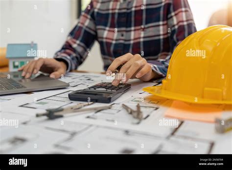 Close Up Architect Or Engineer Using On Calculator For Calculating Value Estimating For Safety