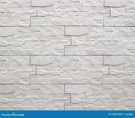 White Cladding Wall Made Of Stoneware With Interlocking Tiles Background And Texture Stock