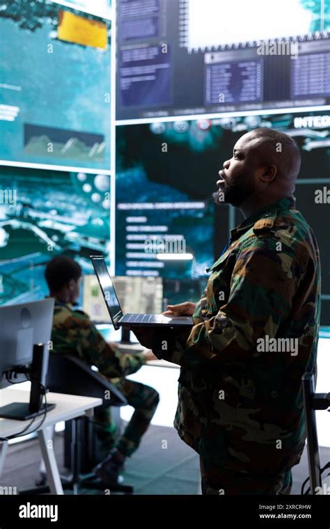 Team Of Military Specialists Overseeing Surveillance Activity By Using A Cctv Footage And Radar