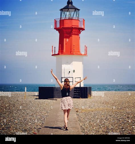 Woman Standing In Front Of Lighthouse Stock Photo Alamy