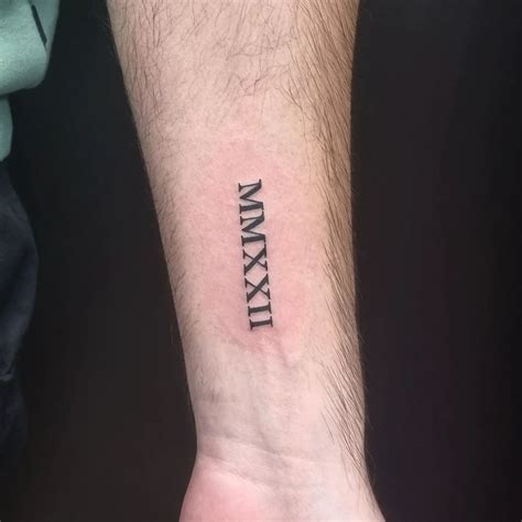 Forearm Male Roman Numerals Tattoo