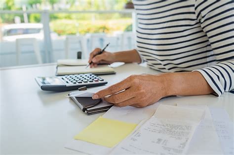 Premium Photo Woman With Bills And Calculator Woman Using Calculator To Calculate Bills At