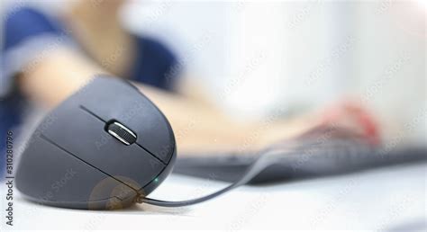 girl s hand uses a vertical ergonomic computer mouse joystick ภาพถายสตอก Adobe Stock