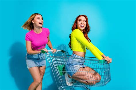 Two Cheerful Young Women Having Fun Against Teal Background Stock