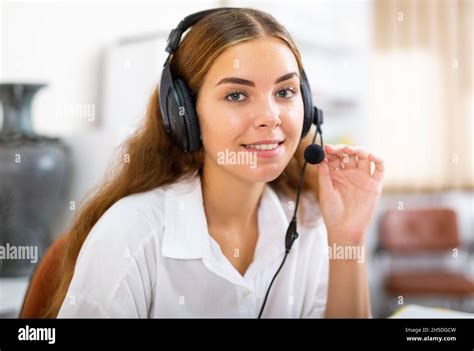 Portrait Of A Smiling Young Operator Girl In The Office With Headphones
